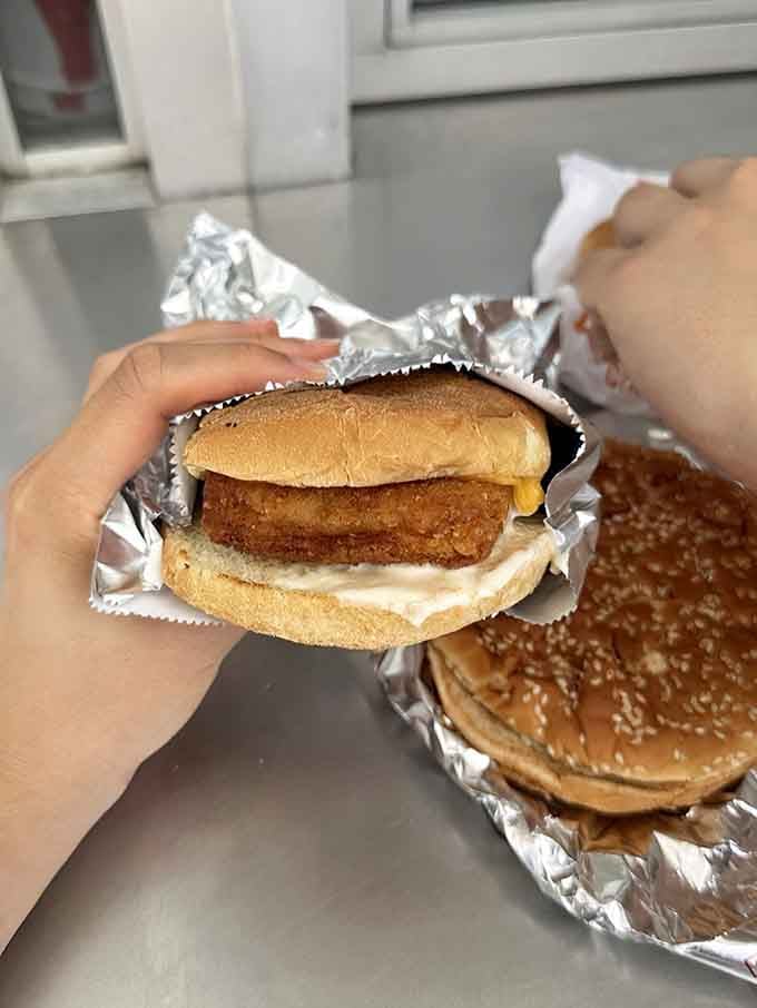 Crispy, golden, and tucked into a soft bun with melted cheese, the fish filet here is a quiet superstar.