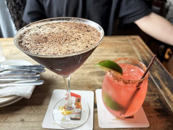 Craft cocktails arrive in elegant glassware, each one a liquid tribute to the art of mixology.