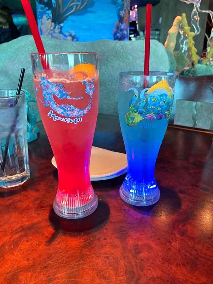 Bright blue and red beverages in novelty glasses: because sometimes adulting means drinking from something ridiculously fun.