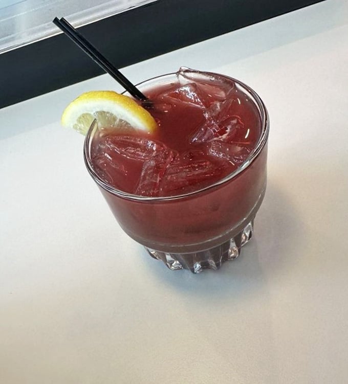 This ruby-red cocktail looks like liquid happiness served in a glass with a citrus crown on top.