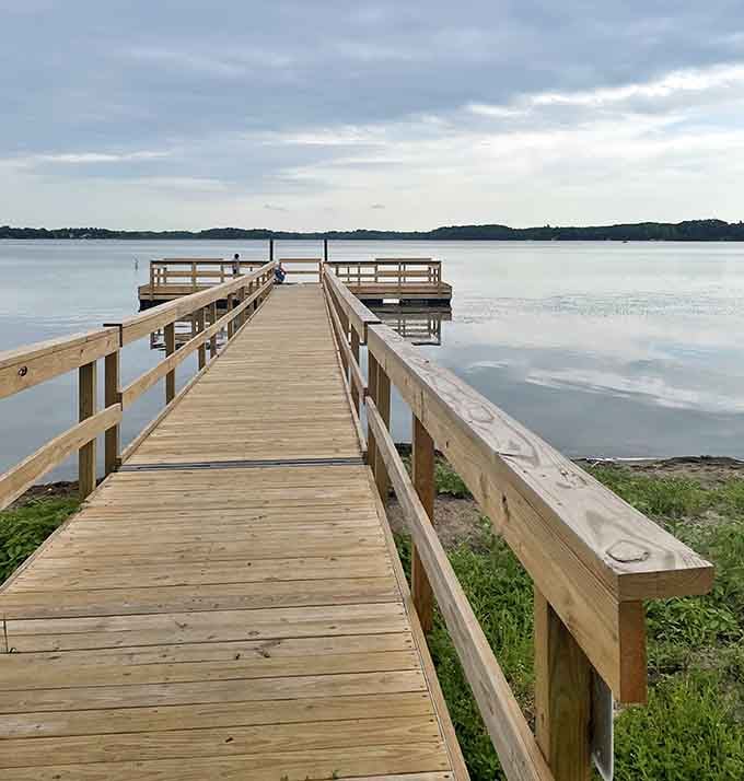 Fishing piers stretching into Lake Independence, where patience meets possibility and fish stories are born every single summer day.