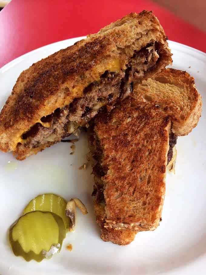 The patty melt on grilled wheat bread with pickles is basically a hug in sandwich form.