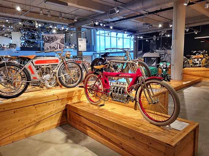 Early motorcycles lined up like mechanical time travelers, each one representing a bold leap forward in engineering history.