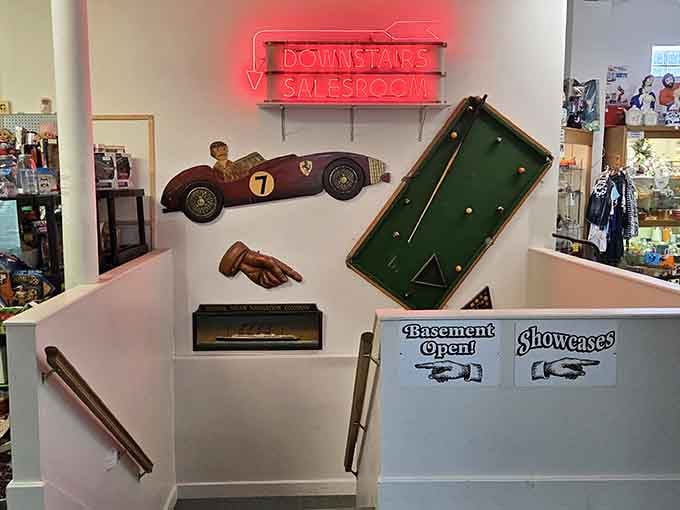 That neon "DOWNSTAIRS SALESROOM" sign means more treasures await below, because one floor of vintage goodness simply isn't enough here.
