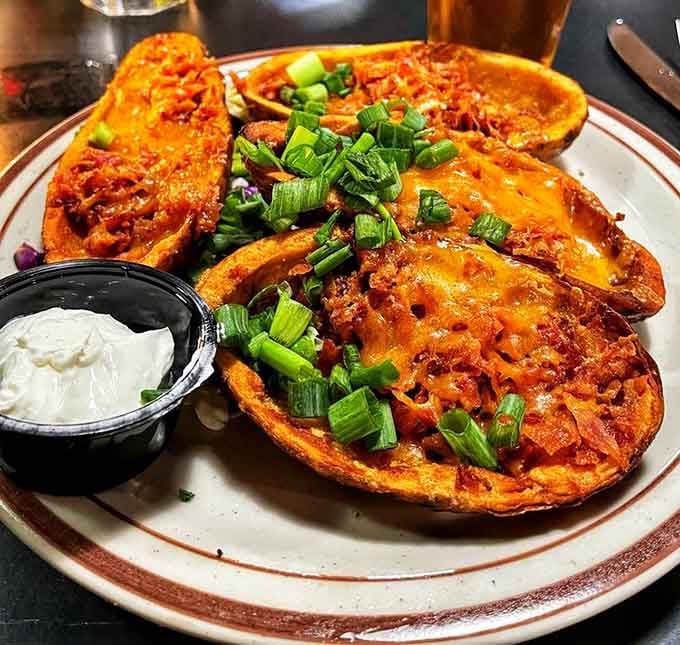 Potato skins loaded with cheese and toppings arrive looking like they could feed your entire hiking group with leftovers.