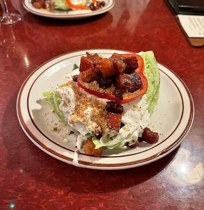 A wedge salad topped with candied bacon proves that sometimes simple done right beats complicated done wrong.