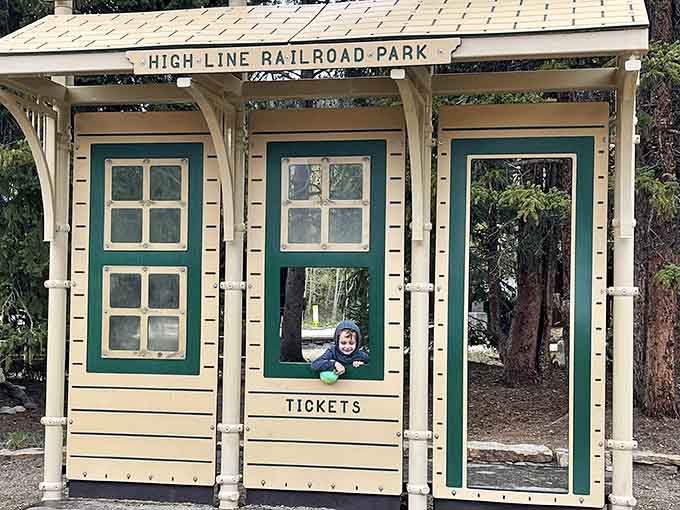 This charming ticket booth window frames curious young faces, sparking imaginations about journeys taken long before their time.