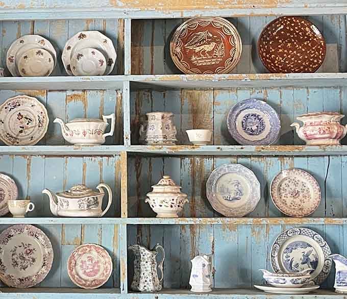 Delicate teapots and hand-painted plates line the shelves like artifacts from a gentler, more deliberate era.