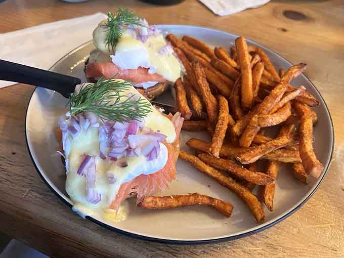 Eggs Benedict with sweet potato fries proves that breakfast doesn't have to choose between fancy and fun &ndash; it can be both.