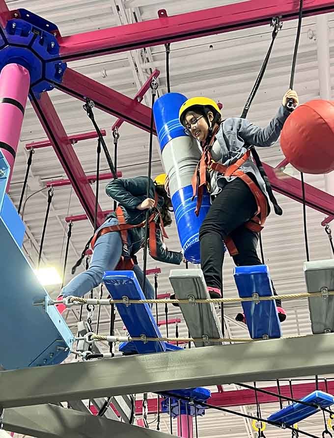 Suspended high above, this ropes course turns ordinary folks into daring adventurers with safety harnesses and determination.