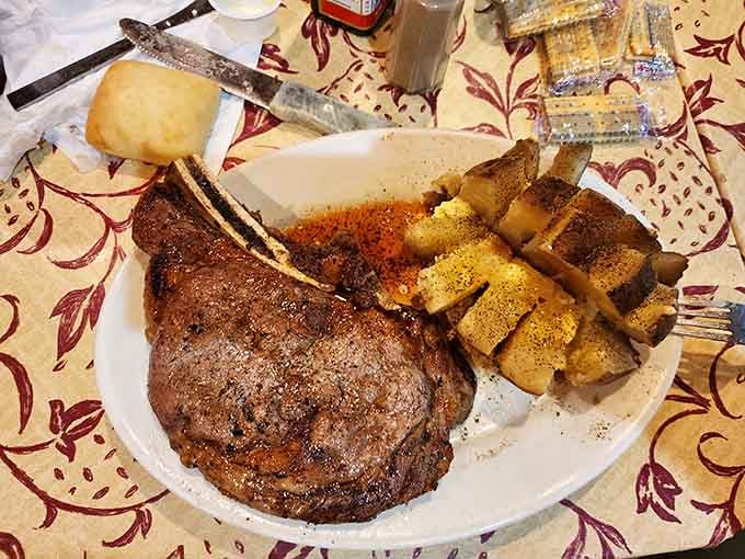 This massive ribeye with seasoned potatoes represents everything right about traditional American steakhouse dining.