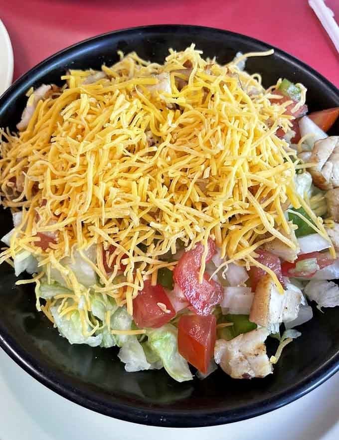 Mountains of cheese crown this grilled chicken salad like it's being coronated for deliciousness royalty today.