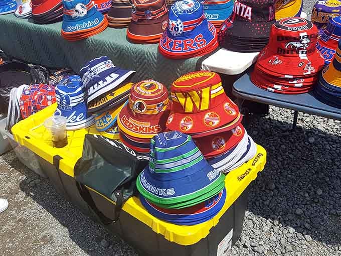 Sports bucket hats stacked high in team colors, letting fans show their loyalty without breaking the bank on stadium merchandise.