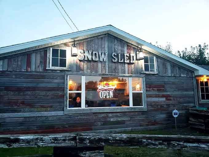 Snow Sled Inn's rustic exterior promises the kind of atmosphere where everyone knows your drink order eventually.