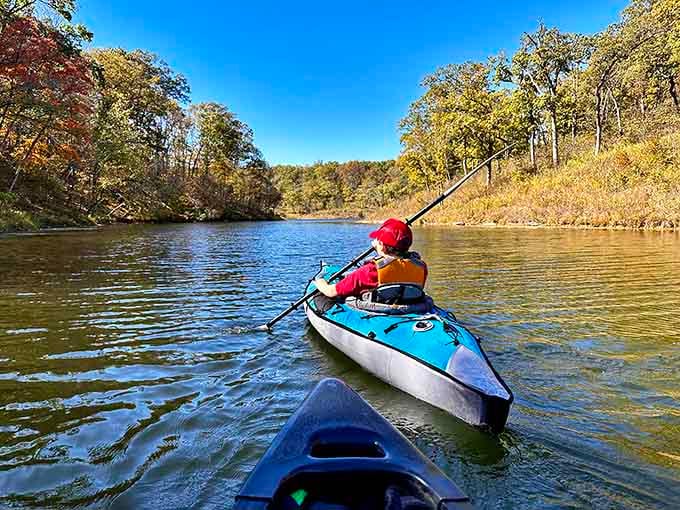 Autumn kayaking means paddling through a living postcard where the trees show off their best fall wardrobe.