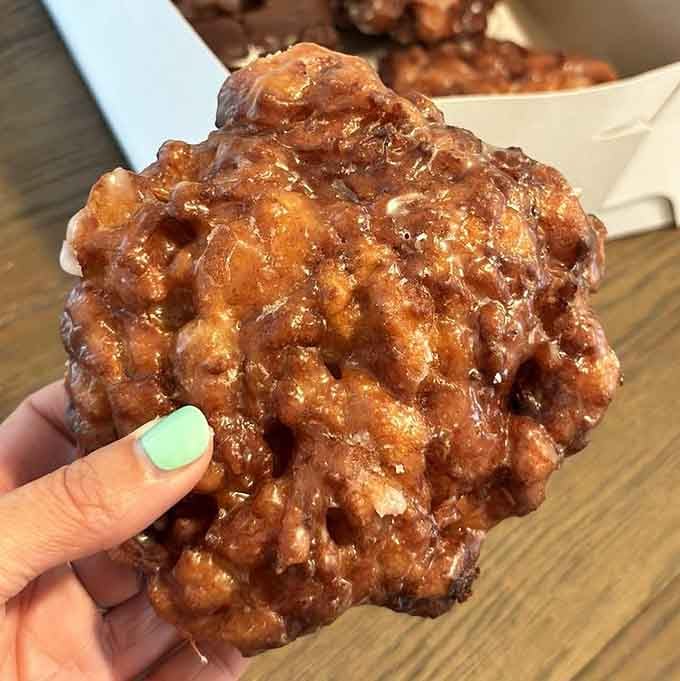 This apple fritter could double as a small planet, gloriously lumpy and glistening with possibility.