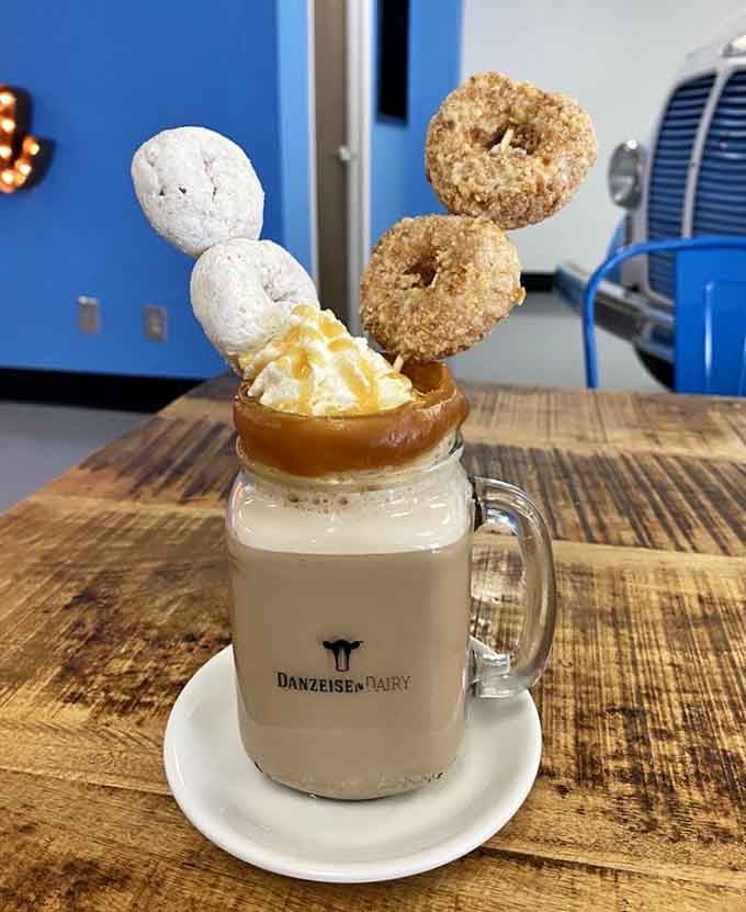 Donuts perched atop coffee like they're staging a breakfast rebellion against boring morning routines.