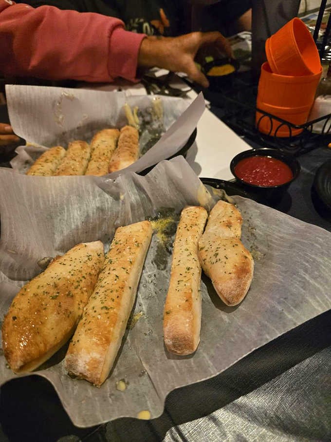 Breadsticks so perfectly golden they could moonlight as props in a food photography magazine spread.