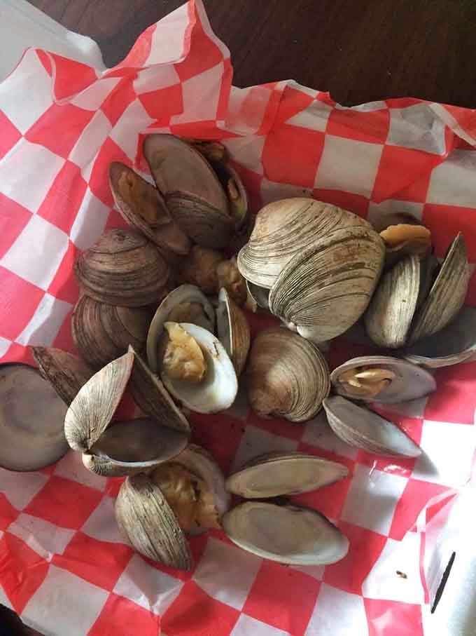 Steamed clams in a checkered basket represent coastal dining at its finest, simple and absolutely delicious every time.