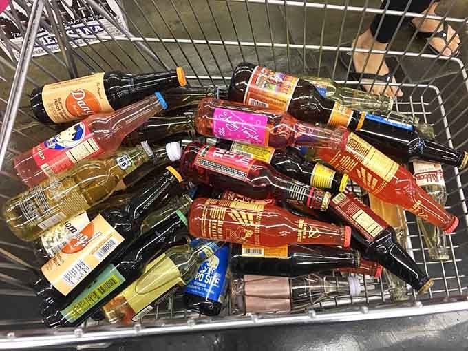 A shopping basket overflowing with glass bottles from around the world, each one a fizzy adventure waiting to happen.