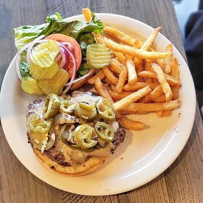 A burger topped with jalape&ntilde;os and served with crispy fries proves lunch here is just as serious as breakfast.