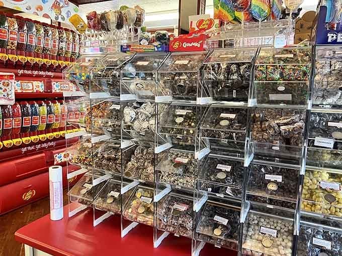 Clear acrylic bins showcase the candy like edible jewels, making every selection feel like a treasure hunt with delicious rewards.