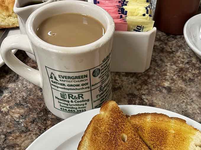Hot coffee in a community mug alongside buttered toast: breakfast done right, no complications necessary here.