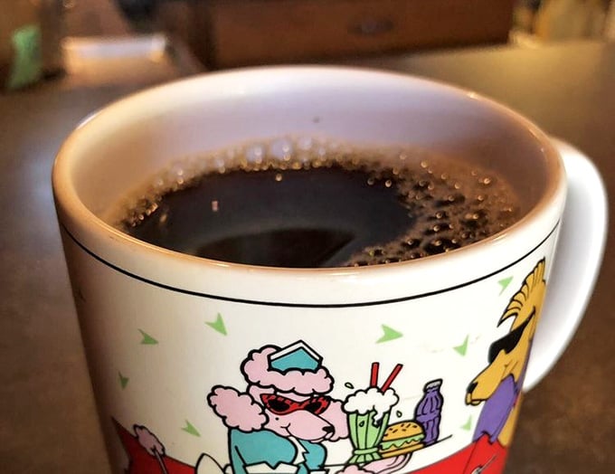 Hot coffee in a cheerful mug, because even your caffeine delivery system should make you smile a little.