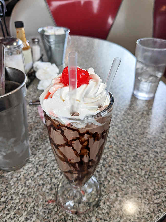 That milkshake topped with whipped cream and a cherry belongs in a Norman Rockwell painting.