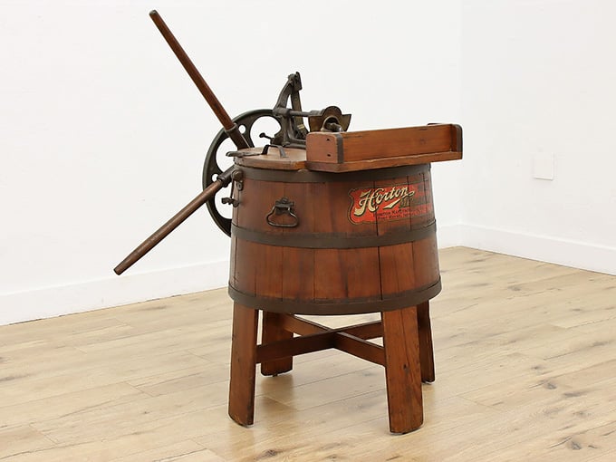 A hand-cranked wooden washing machine that makes you deeply grateful for modern appliances, yet oddly charmed.
