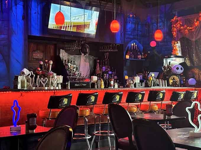 The bar area glows with orange and purple lights, creating a vibe that's equal parts nightclub and haunted mansion.