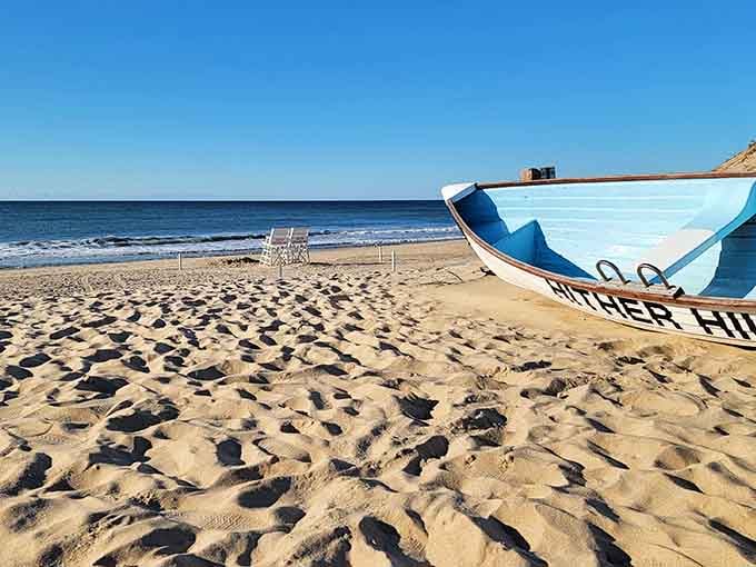 A lifeguard boat resting on sand so fine it could double as a Caribbean beach postcard backdrop.