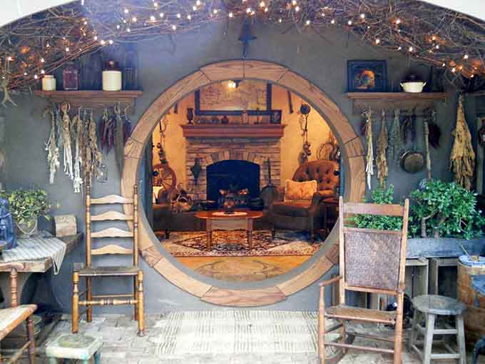 The covered porch area invites lingering conversations and countless photo opportunities with that iconic door.