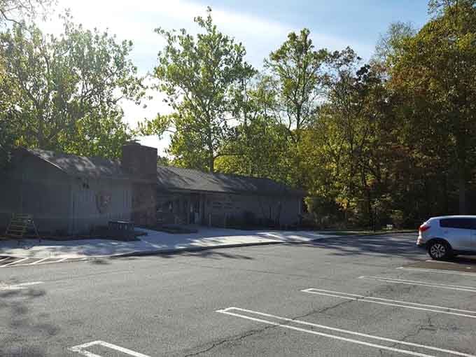 The parking area welcomes modern visitors arriving in vehicles that would have seemed like pure magic to workers.