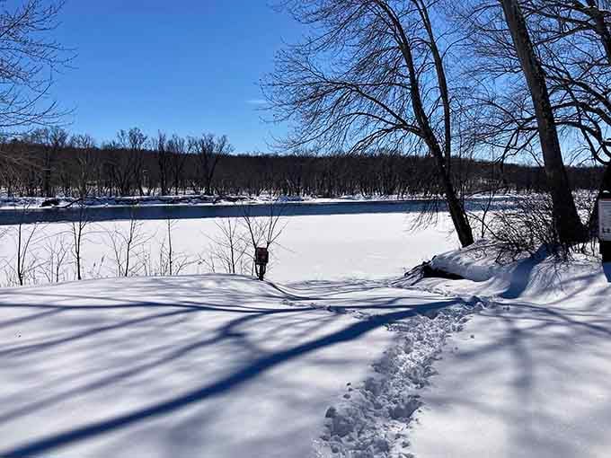 Winter transforms the river into a frozen canvas, peaceful and pristine like nature's own reset button.