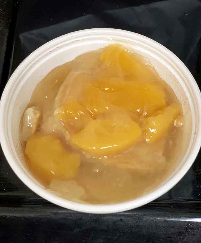 Peach cobbler served warm with fruit still bubbling is the kind of dessert that makes you forget about counting calories.