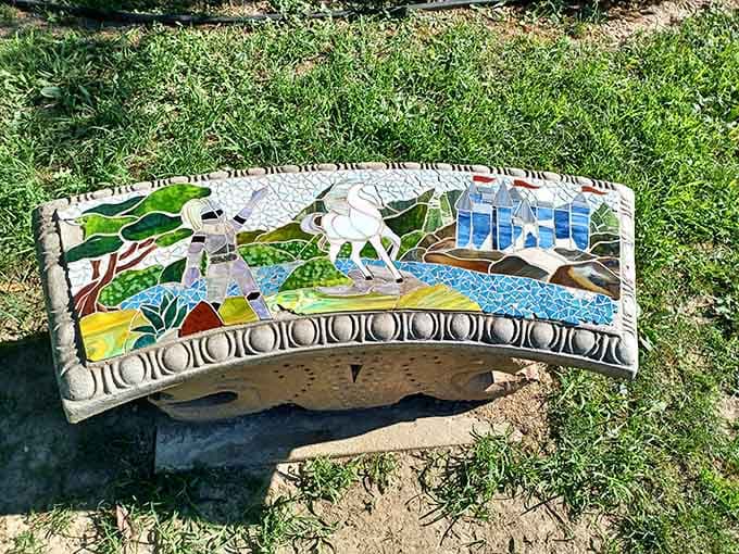 Even the benches here tell stories, decorated with mosaic scenes that transform a simple rest stop into a work of art.