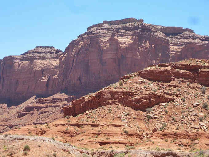 These layered rock formations have been standing here longer than humans have been taking selfies with them.