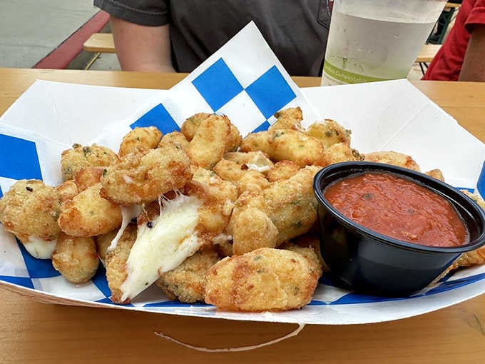 Cheese curds so perfectly fried they squeak with joy, served with marinara for dipping happiness.