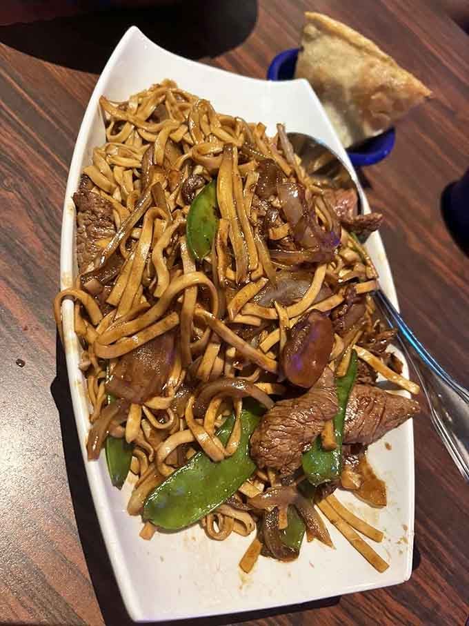 Beef Lo Mein tangles tender meat with noodles in a sauce that makes chopstick skills suddenly seem essential.