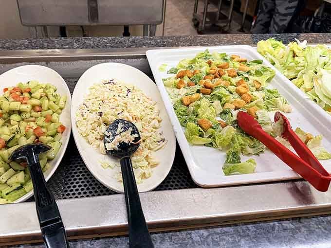 Fresh salads lined up like the responsible choice you'll make after your third trip to the seafood station.