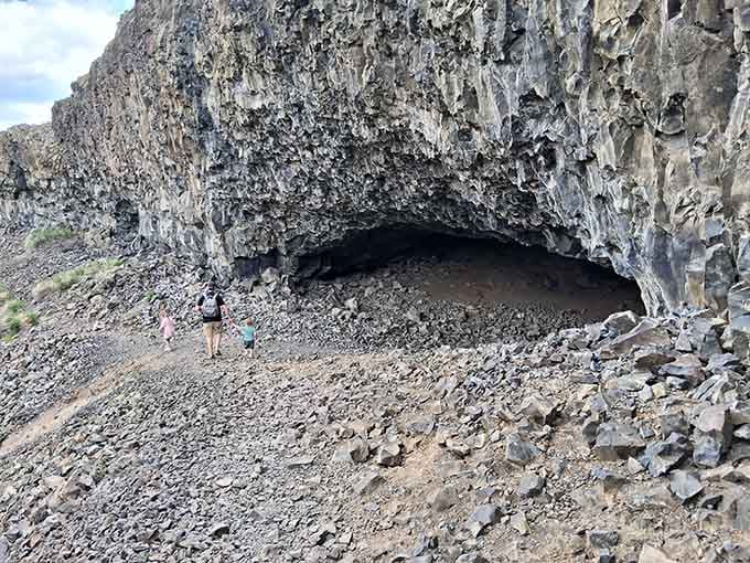 The cave opening is surprisingly massive, offering shelter from sun and weather just like it did millennia ago.