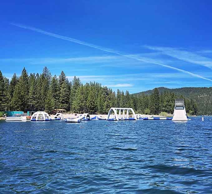 The entire floating playground spreads across the lake like someone ordered a waterpark and forgot to mention land.