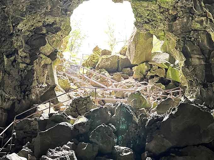 Jagged volcanic rocks frame the entrance like nature's own sculpture garden, hinting at the drama that awaits below.