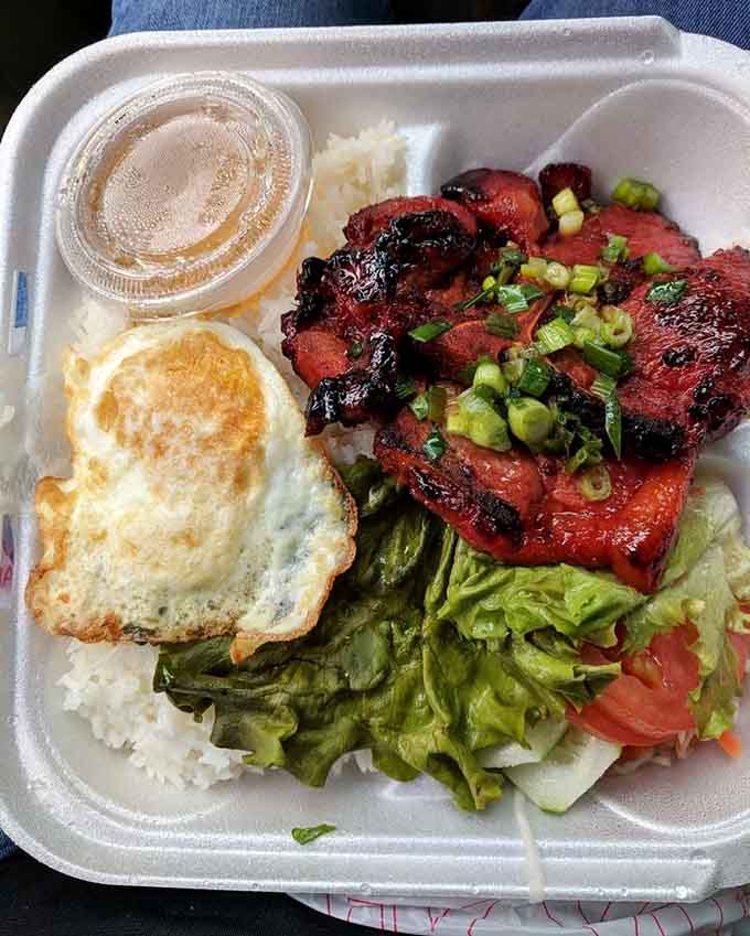 This breakfast plate means business: grilled pork, fried egg, and rice. Your morning just got infinitely better.