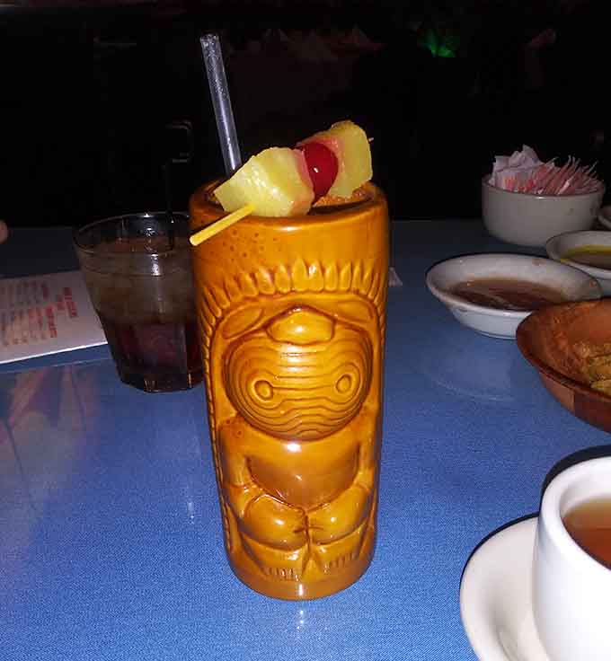 That tiki mug isn't just holding your pi&ntilde;a colada, it's practically begging you to take it home as a souvenir.