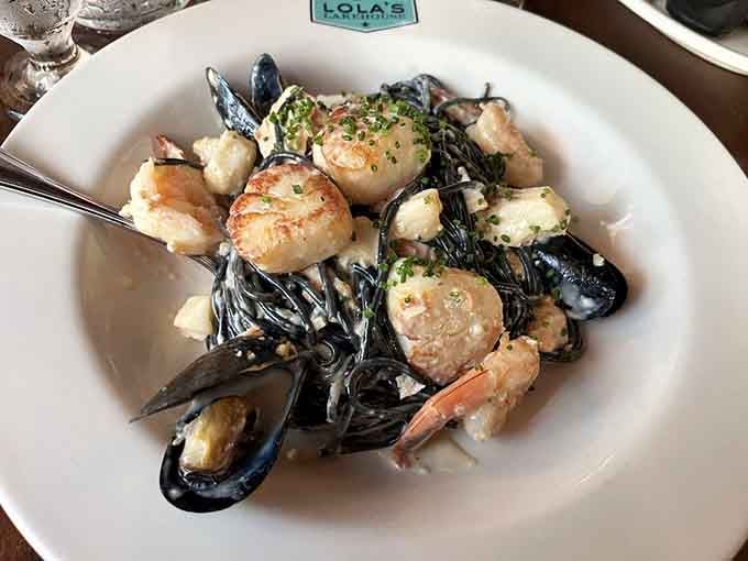 Squid ink pasta with scallops, shrimp, and mussels proves landlocked states can absolutely nail coastal cuisine spectacularly.