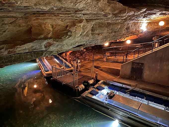 Tour boats wait patiently at the dock, ready to ferry curious explorers through ancient limestone passages below.