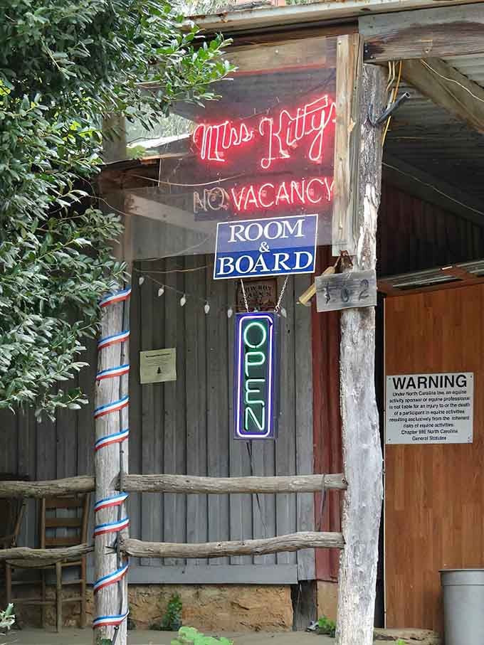 Miss Kitty's neon glow promises old-fashioned hospitality in a town where "no vacancy" actually means people want to stay.