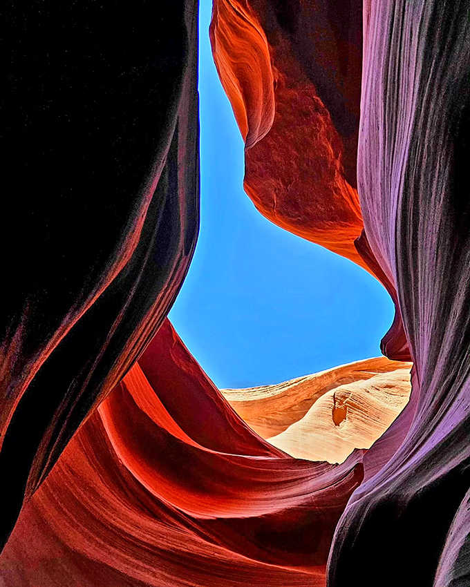 The rock curves like frozen waves, each layer telling stories from when dinosaurs were still the dominant species.